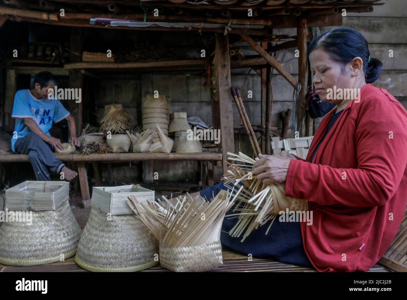 Worker weaving a bamboo rice eco-friendly basket in Bogor, West Java ...
