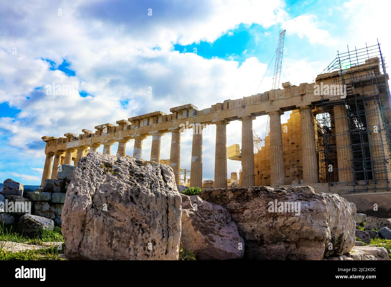 Fallen columns in front of the Parthenon on the Athens Greece Acropolis with scaffolding and a ...