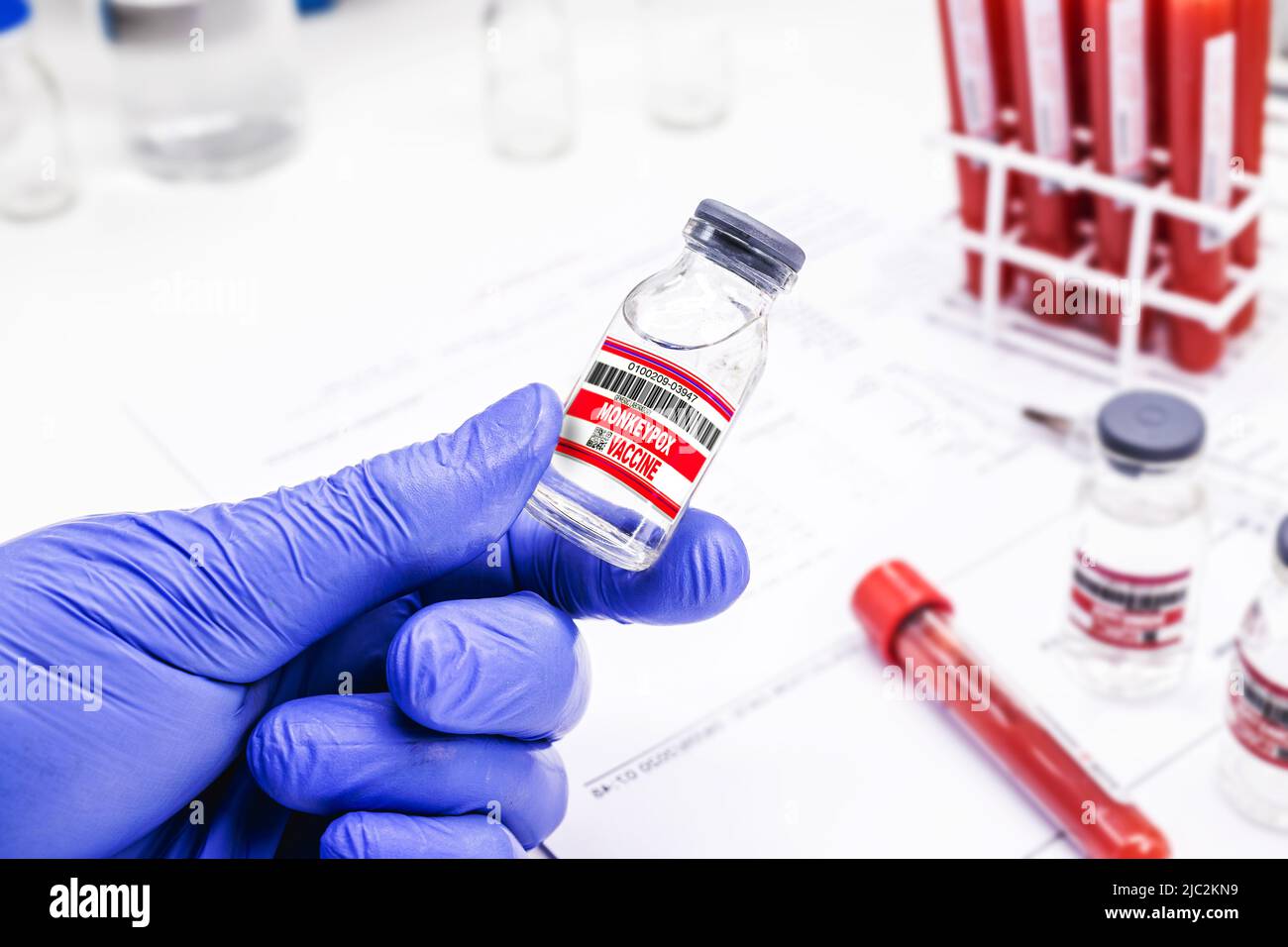 pharmacist's hand with latex glove holding monkeypox vaccine ...