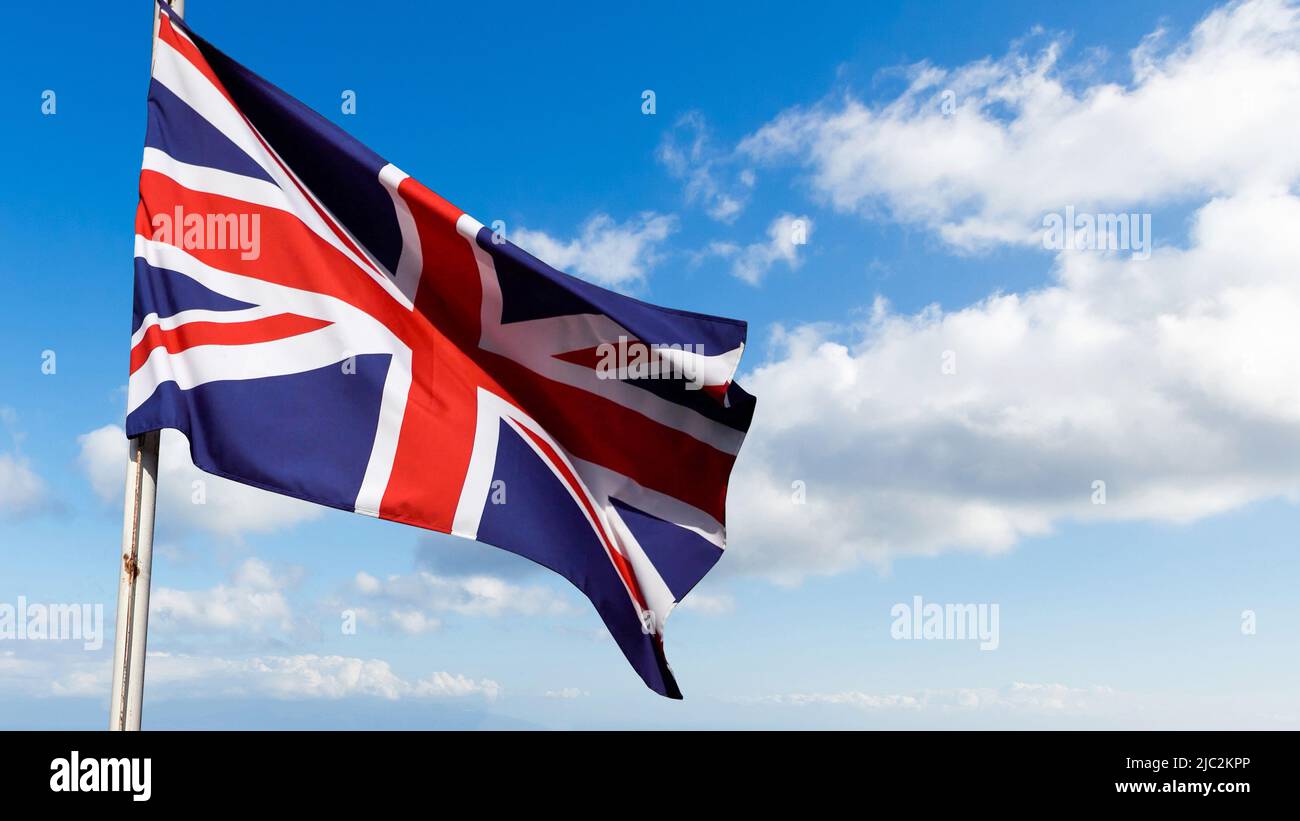 Flag of the United Kingdom on blue sky. illustration Stock Photo - Alamy