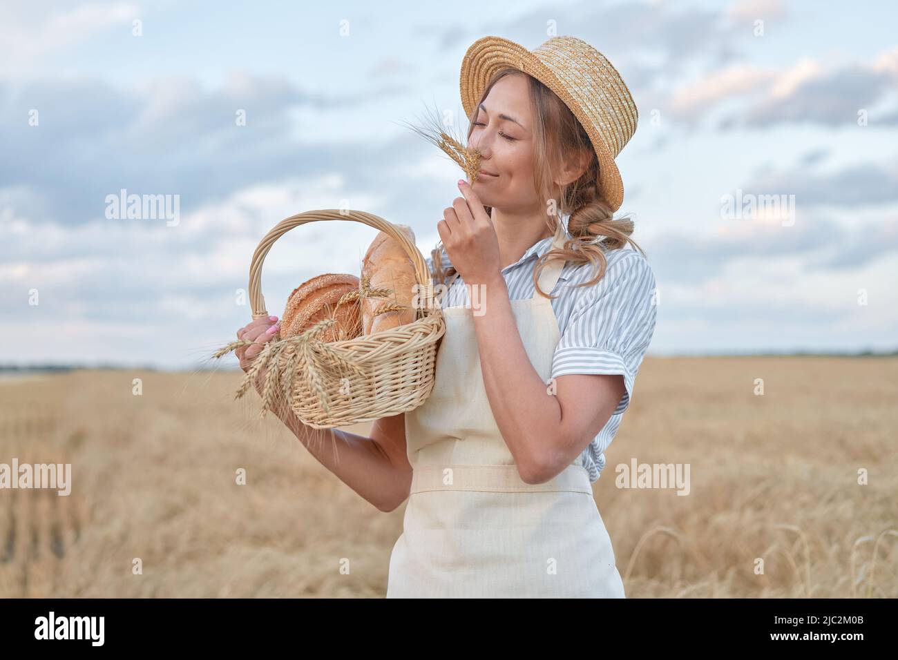 Female farmer standing wheat agricultural field Woman baker holding ...