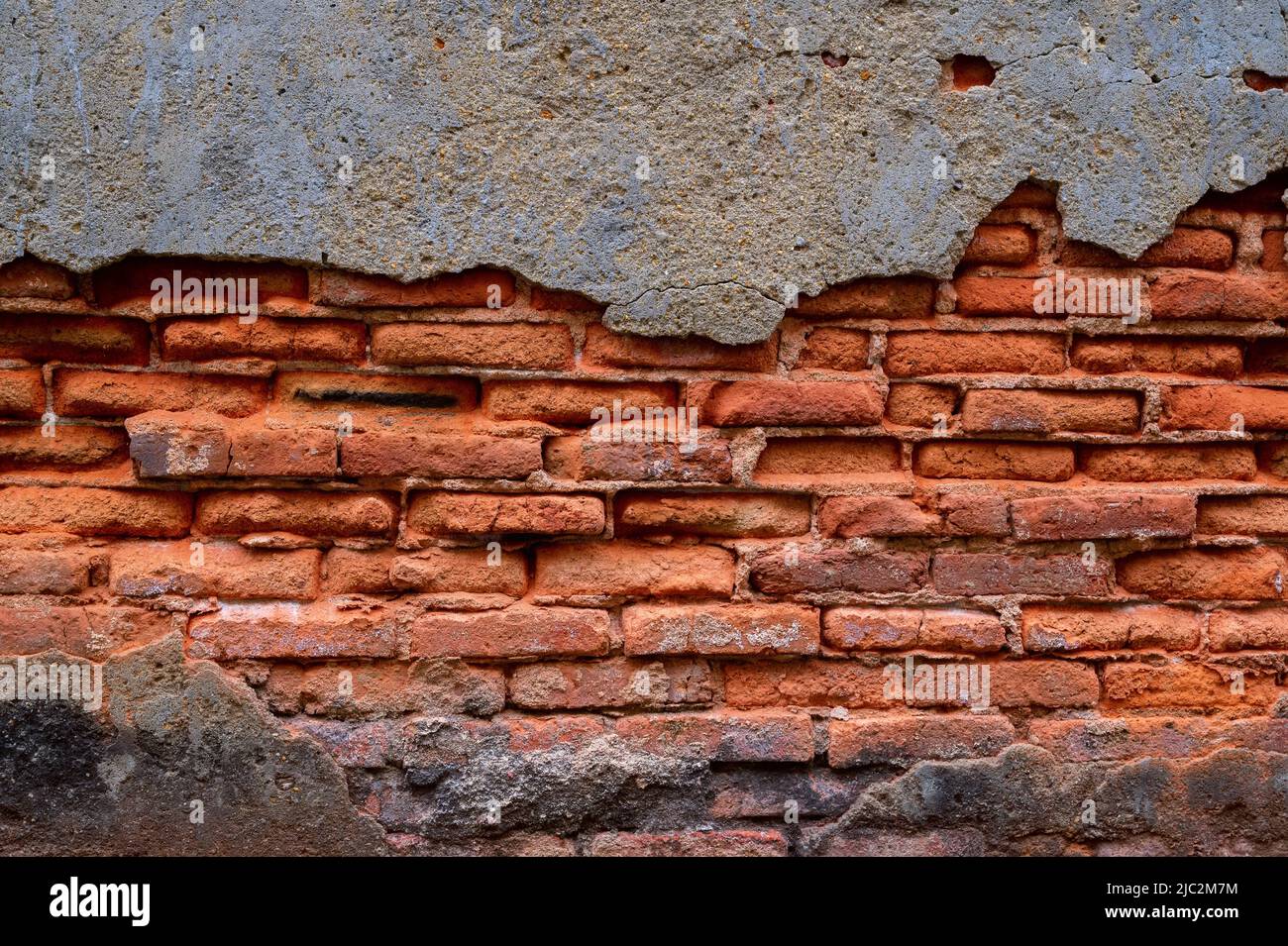 Old wall of gray plaster and red bricks textured background in fort of ...