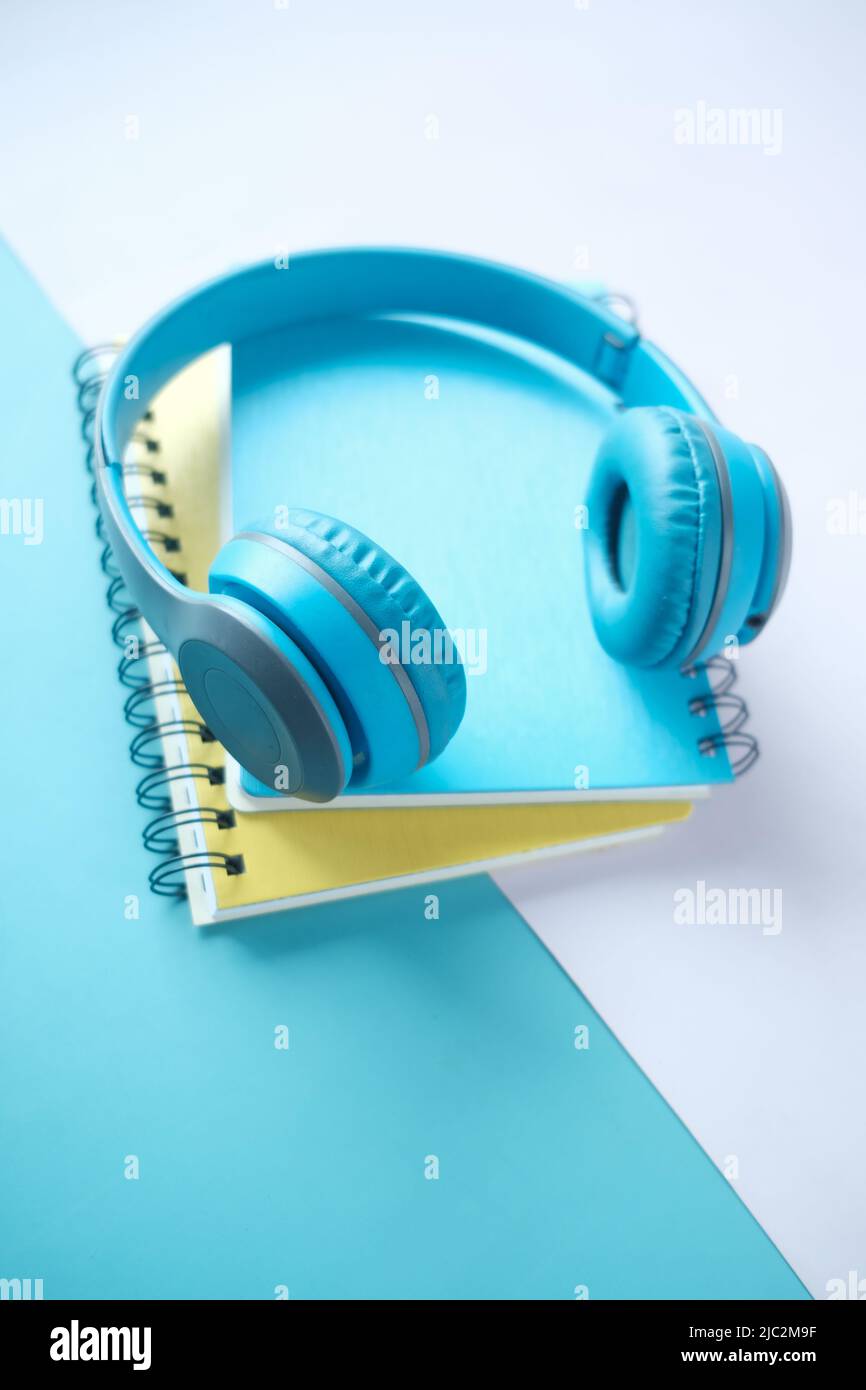 Audio book concept. Headphones and notepad on table Stock Photo - Alamy