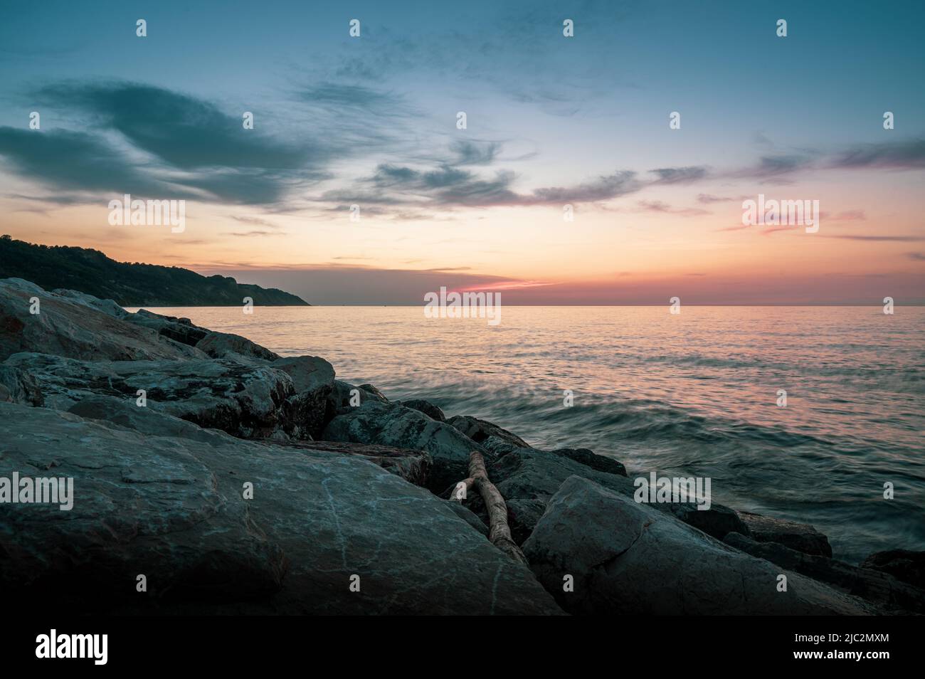 sunset over the sea with cliff Stock Photo - Alamy