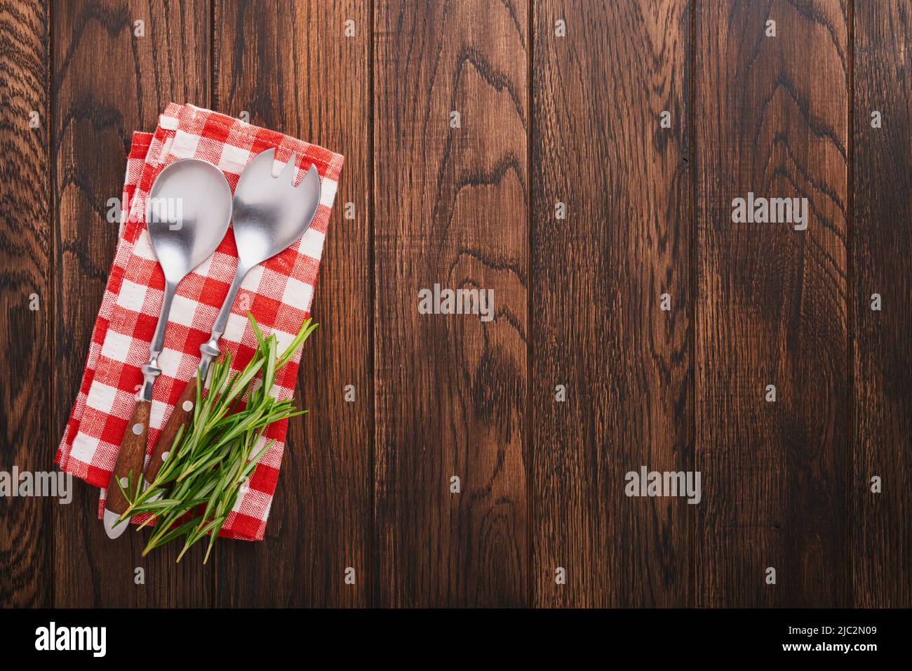 Food background. Salt, pepper, rosemary branch, wooden stand, salad ...