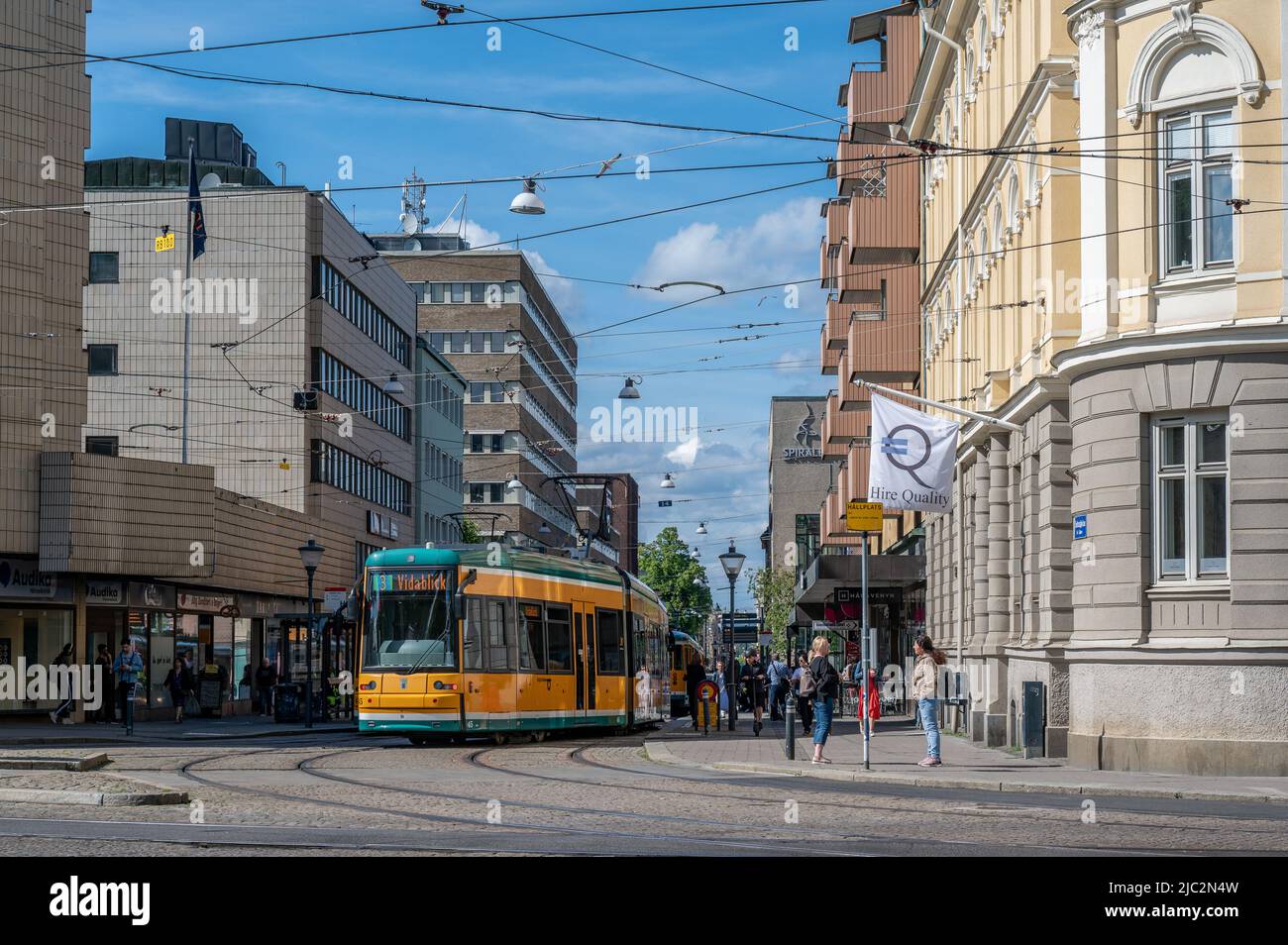 Tram on Main street Drottninggatan in the city center of Norrkoping ...