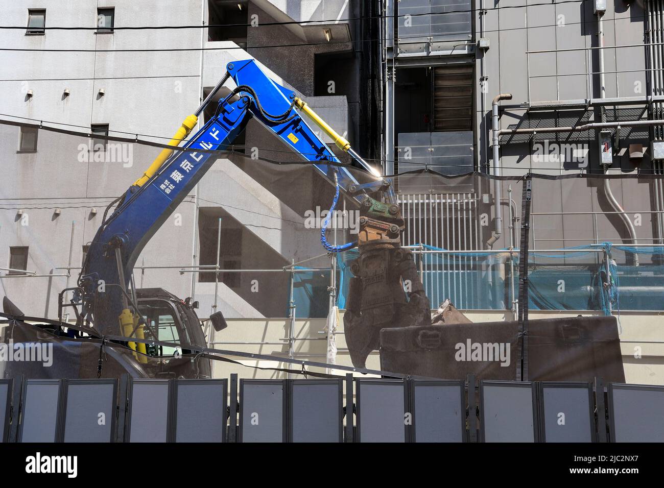 A bulldozer demolishes a capsule dismantled at Nakagin Capsule Tower in ...