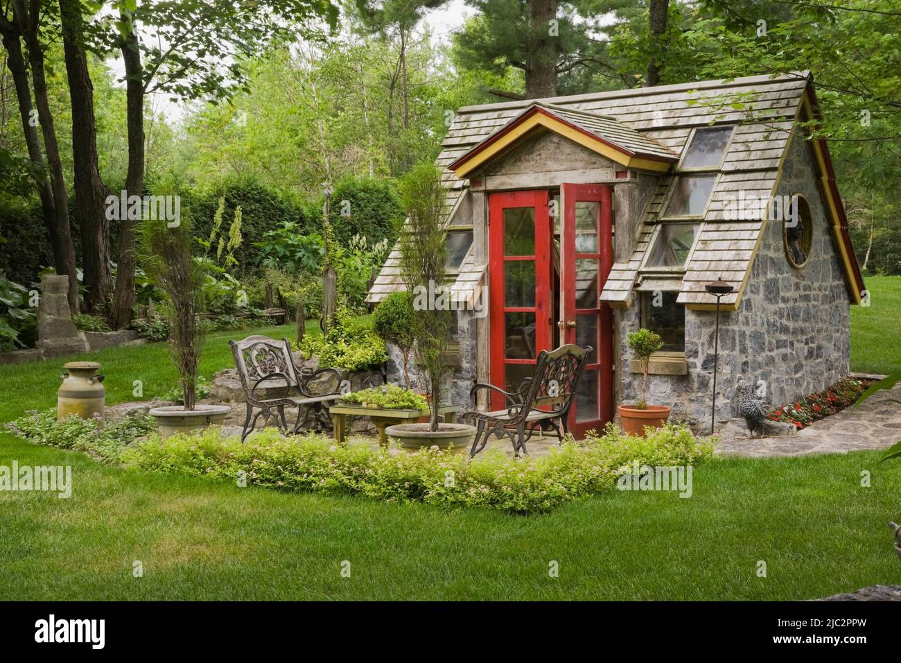 Reading pavilion in landscaped residential backyard garden in summer ...