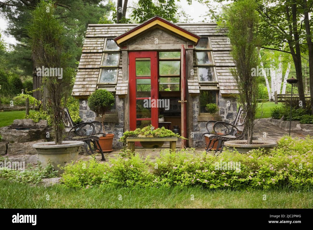 Reading pavilion in landscaped residential backyard garden in summer ...