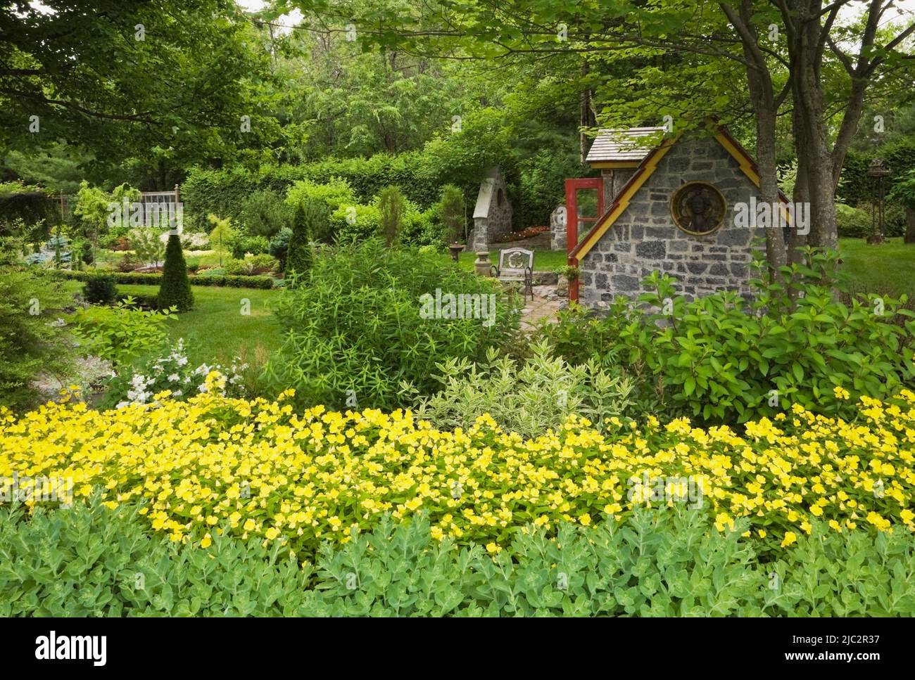 Reading pavilion in landscaped residential backyard garden in summer ...