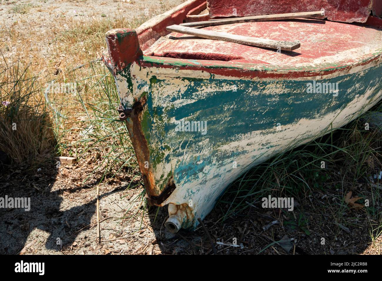 Old weathered vintage fishing boat front side on beach ground Stock ...