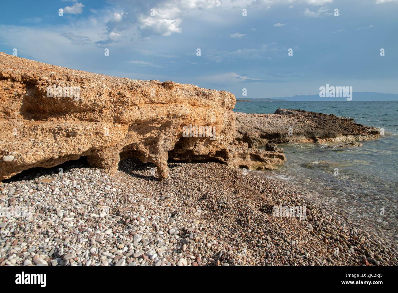 Landscape with eroded rock on the beach in summer time Stock Photo - Alamy