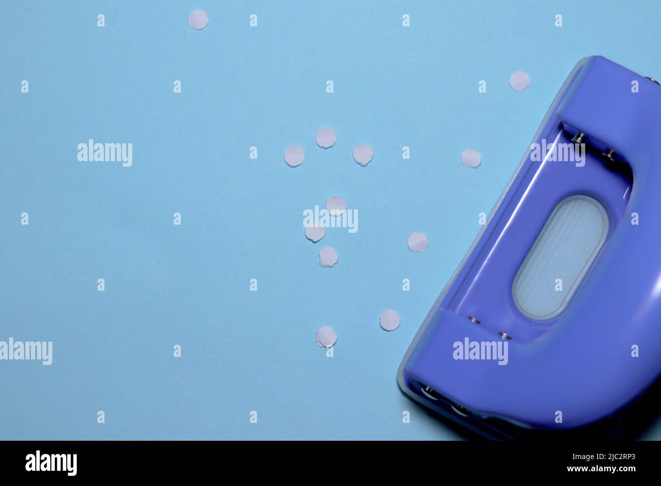 Blue Hole punch or Perforate machine on sky blue background Stock Photo ...