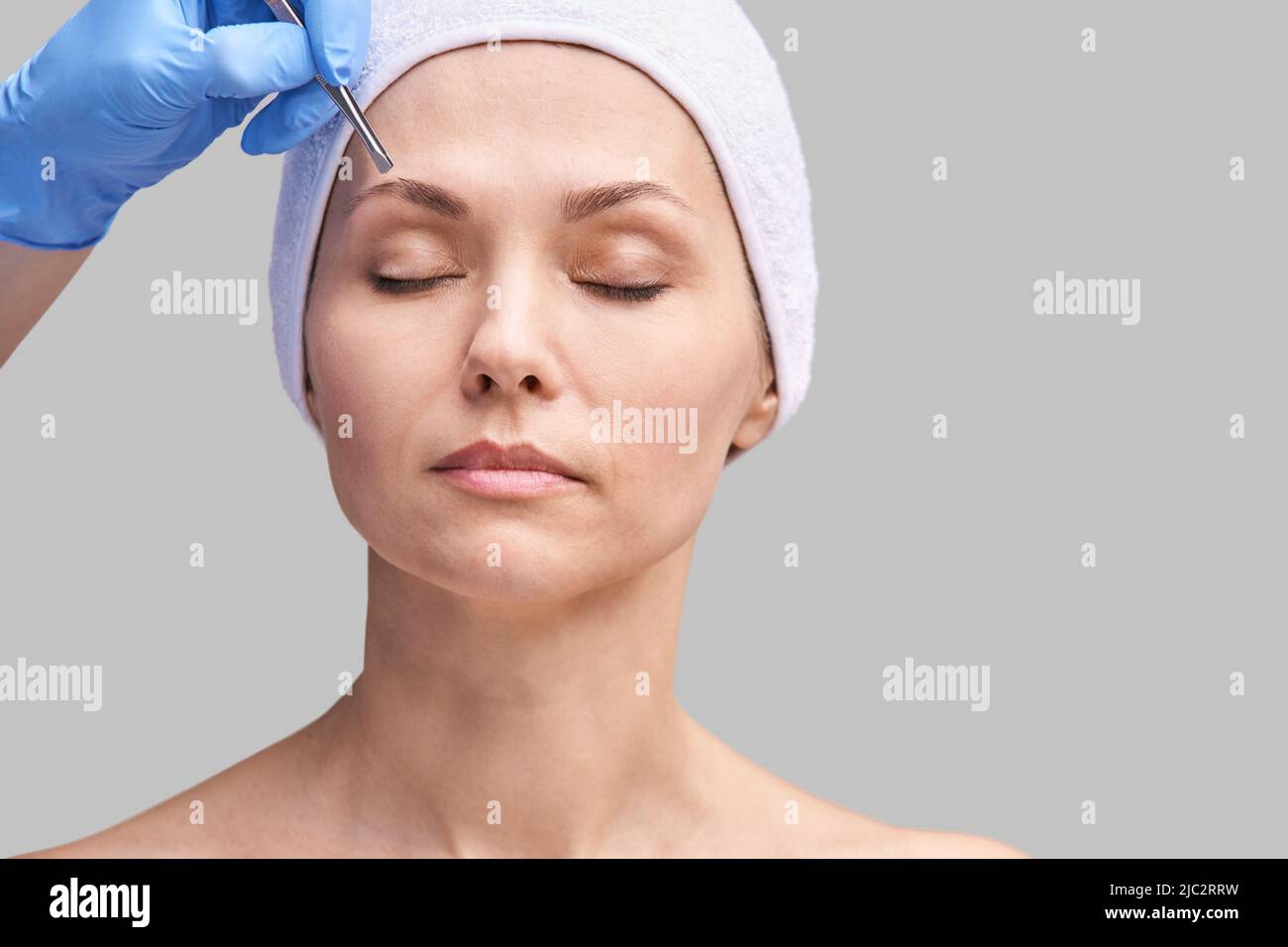 Beautician skin care. Face tweezers. Facial treatment. Woman ...