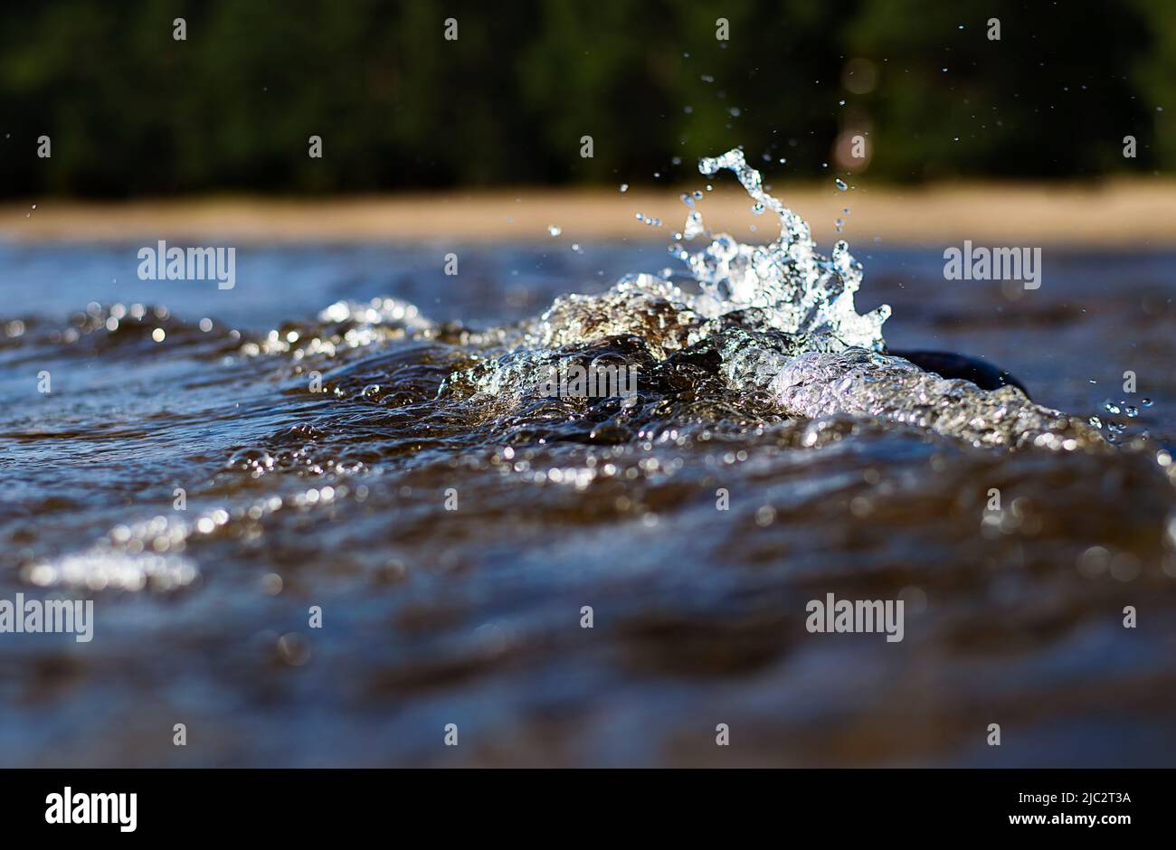 A wave splashing water in a lake Stock Photo - Alamy