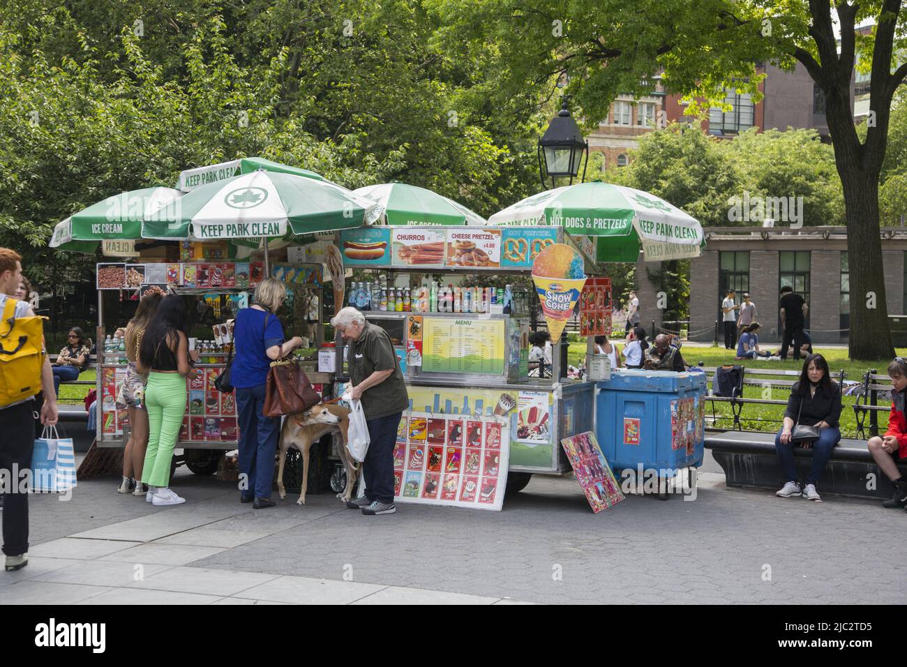 People grab a snack at a food vendor at City Hall Park along Park Row ...