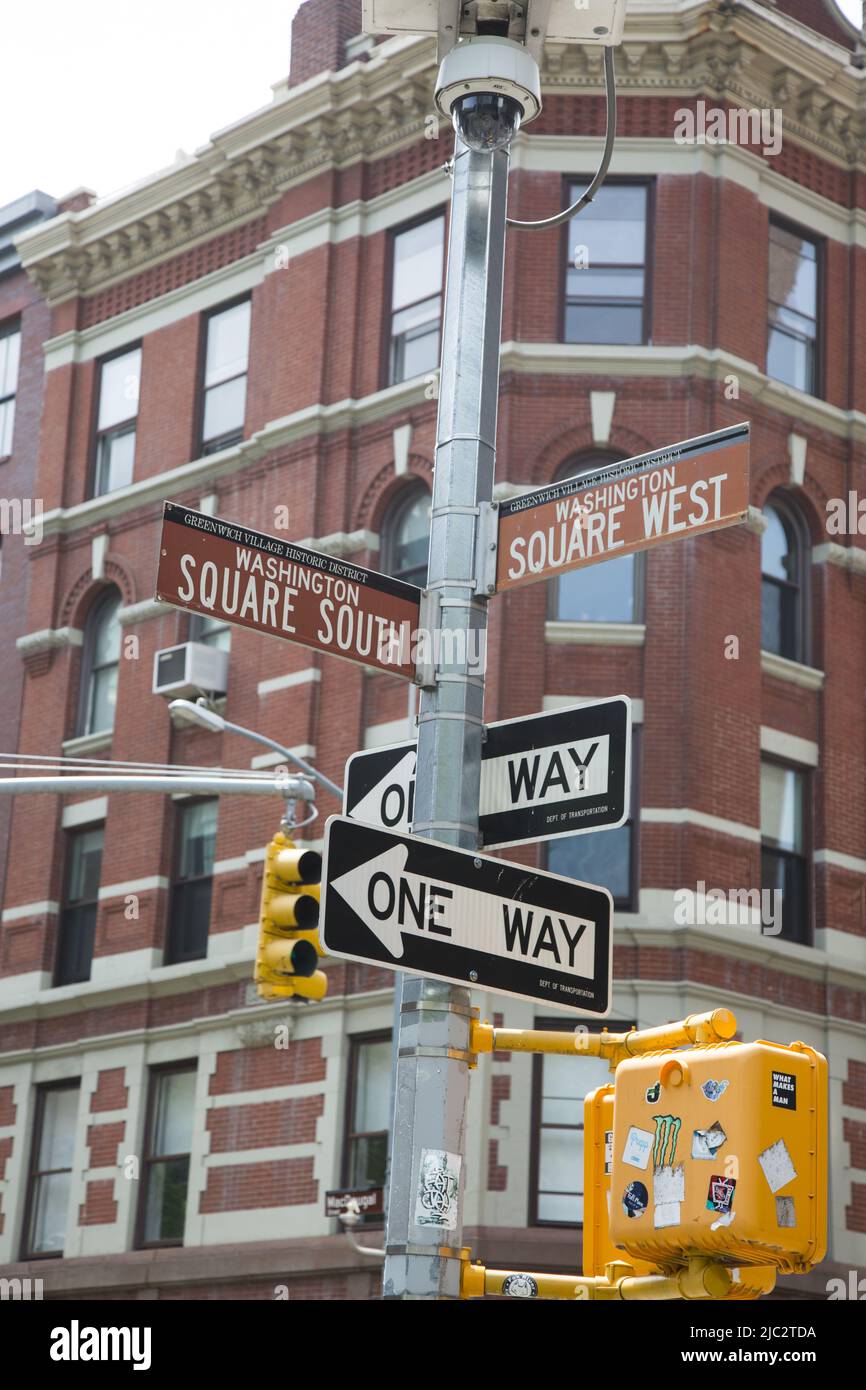 Street signs at the corner of Washington Square South and Washington ...