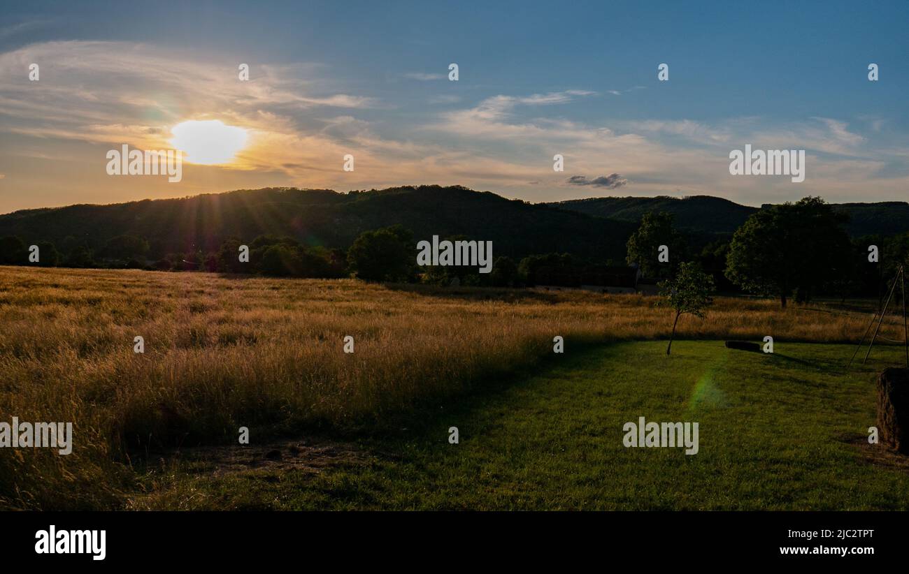 Sunset light on the field Stock Photo - Alamy