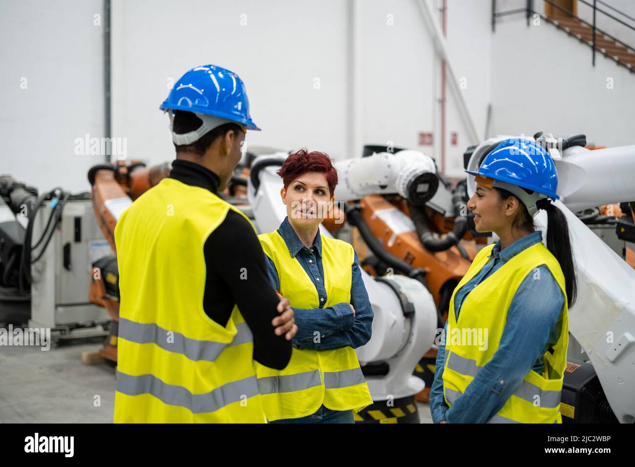 Group of engineers discussing technology in the factory Stock Photo - Alamy