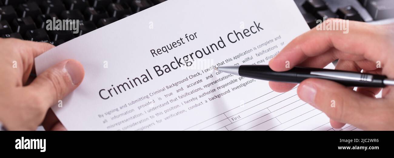 Close-up Of Person Hand Filling Criminal Background Check Application ...