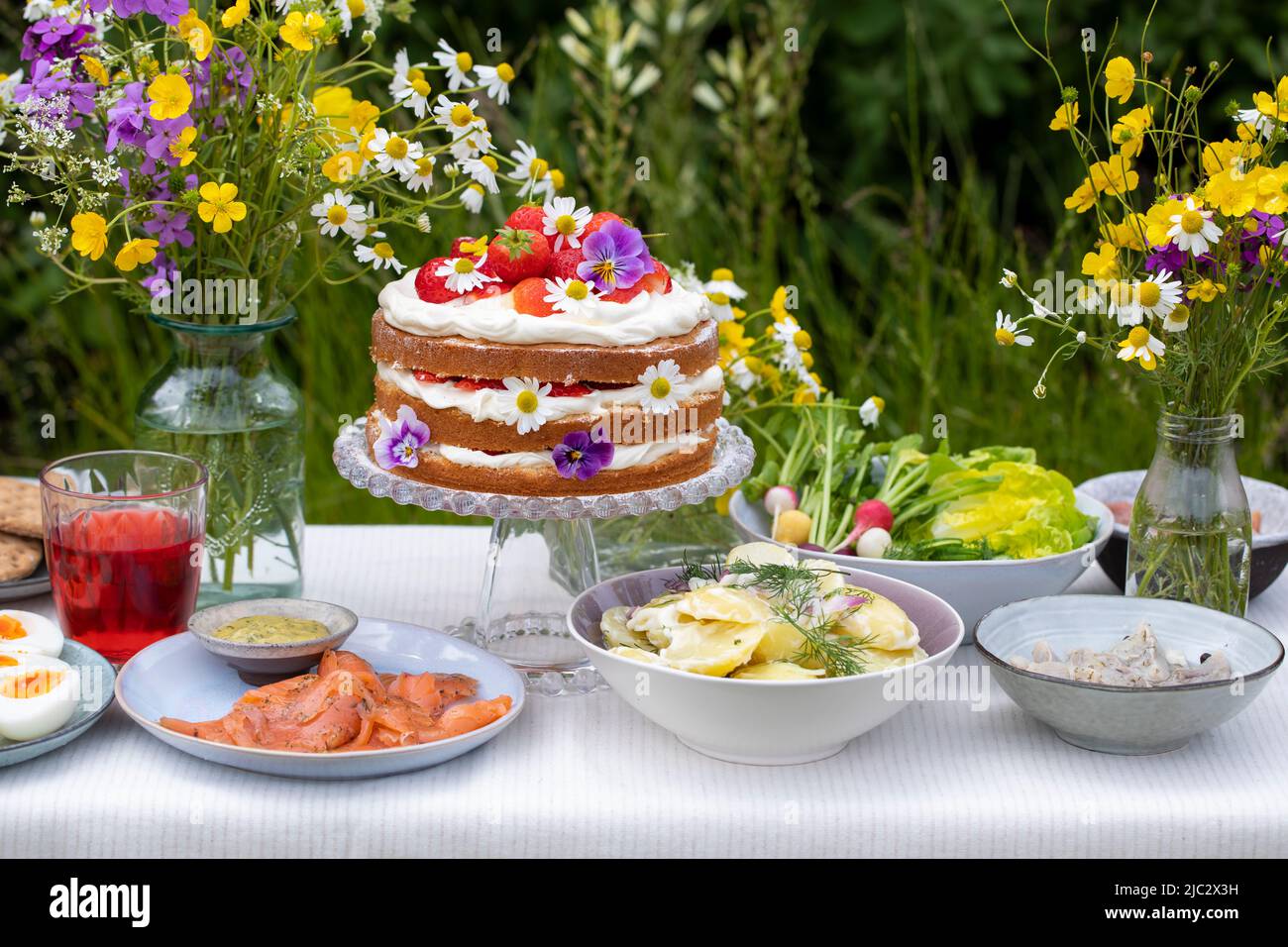 Scandinavian midsummer meal with strawberry and cream cake, potato ...