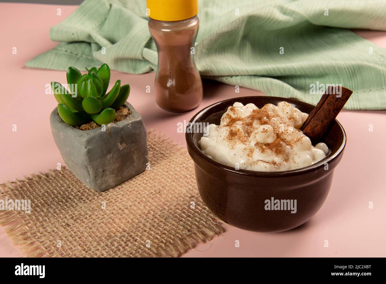 Brazilian sweet dessert, Canjica. White corn porridge with cinnamon and ...