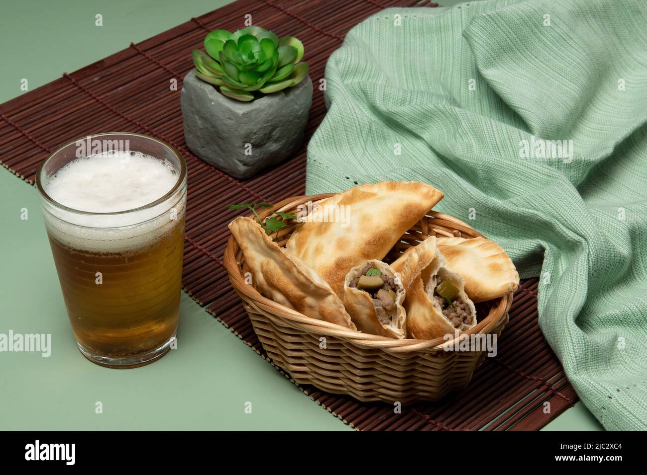 portion of bar meat pastries in a green background Stock Photo - Alamy
