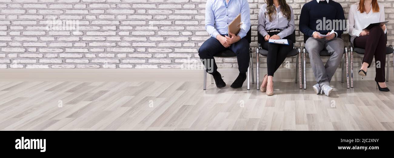 Close-up Of Business People Sitting On Chair Waiting For Job Interview ...