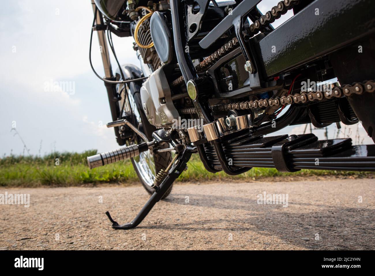 motorcycle details close-up. footrest, drive chain, springs and side ...