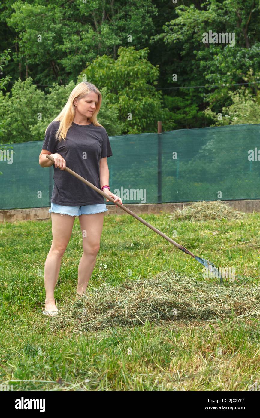 Girl with hay rake hi-res stock photography and images - Alamy