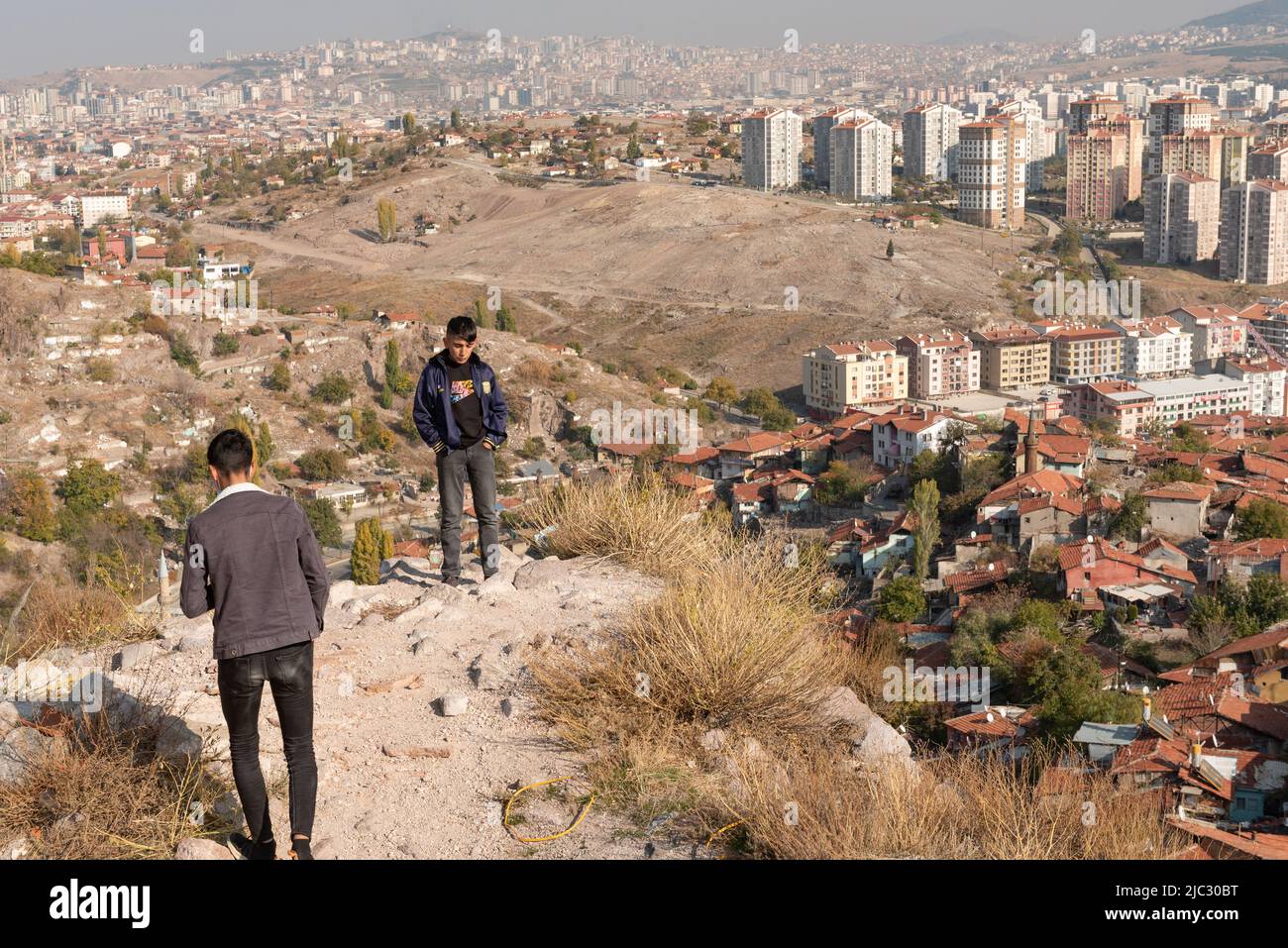 Young Turkish teens seen at Ankara castle with the urban sprawl of the ...