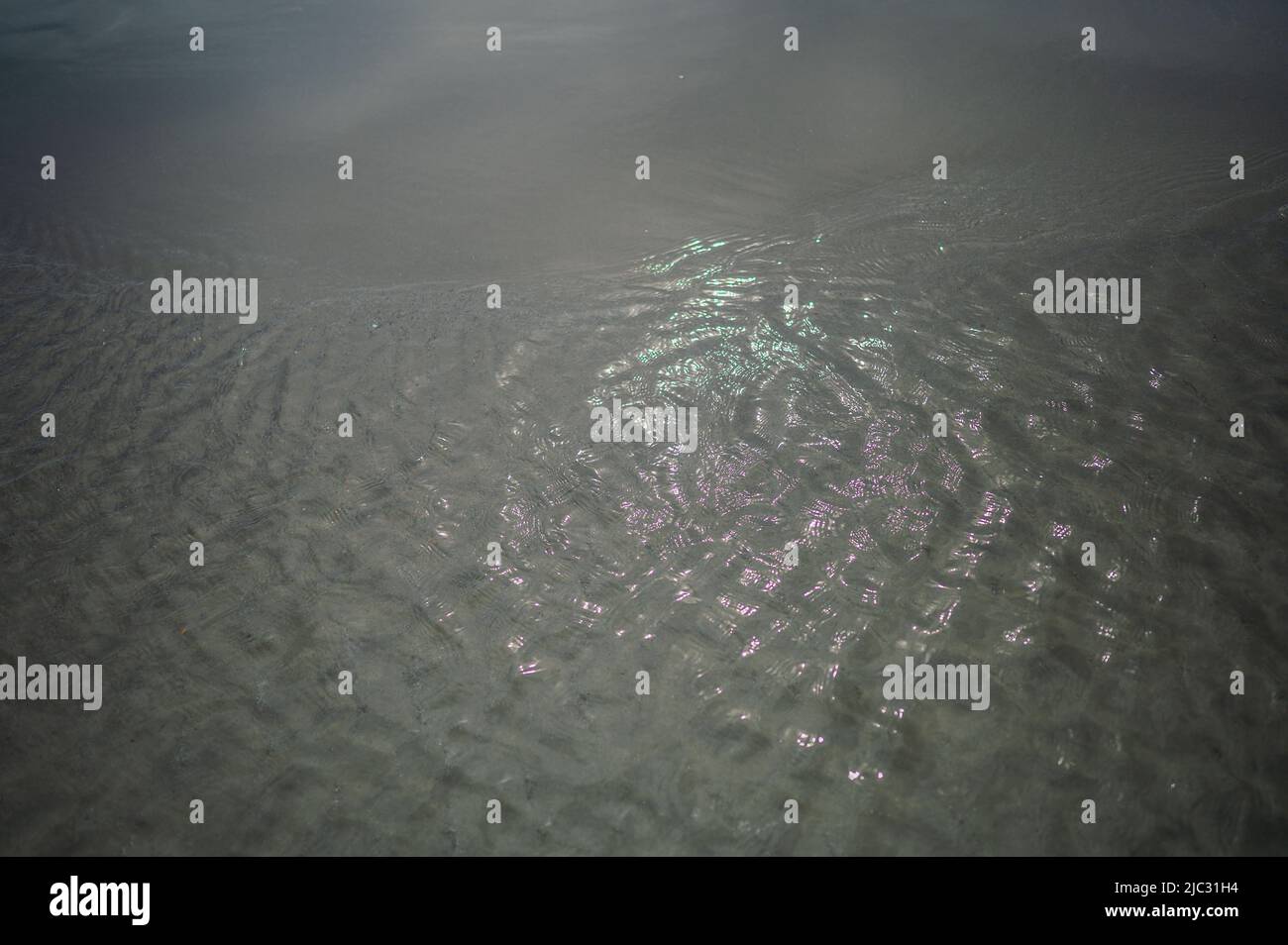 Light reflection on beach water Stock Photo - Alamy