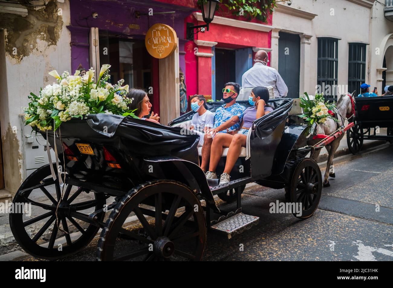 Visitors enjoy horse car ride in old city of Cartagena, Colombia Stock ...