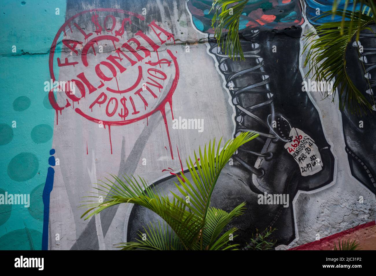 Mural on The "false positives" scandal. Colorful graffitis enrich the ...