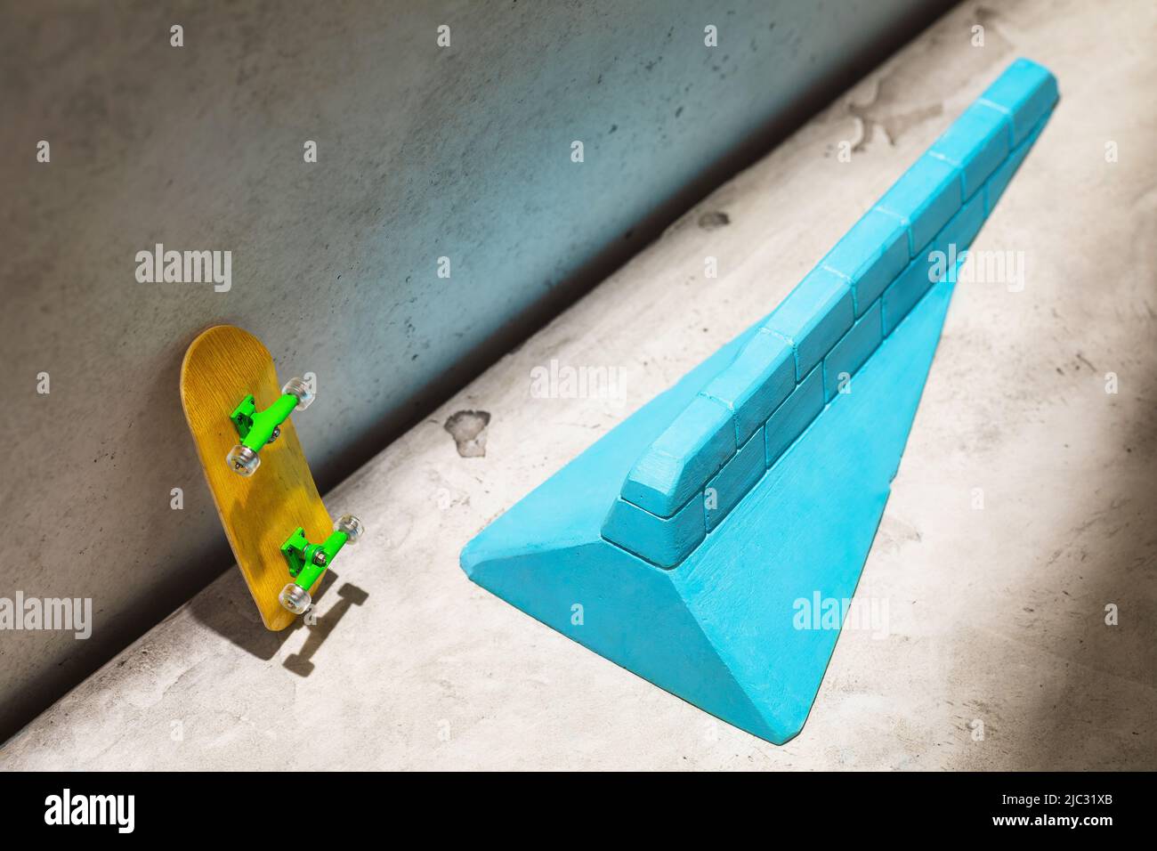 Blue plaster ramp and yellow fingerboard on abstract background Stock ...