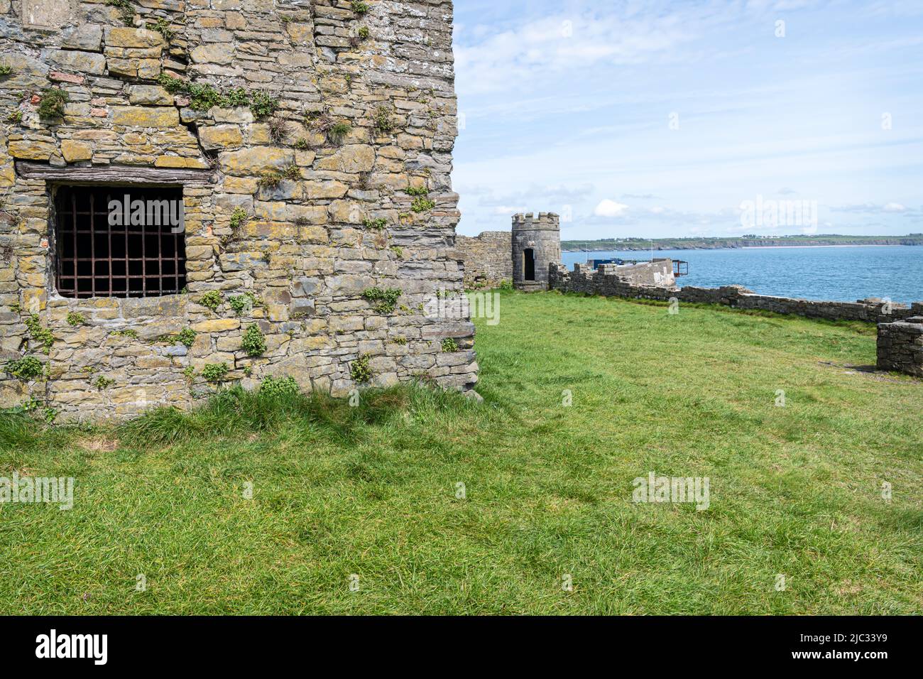 Fortified window in Carrigaholt Castle with the defensive seawall ...