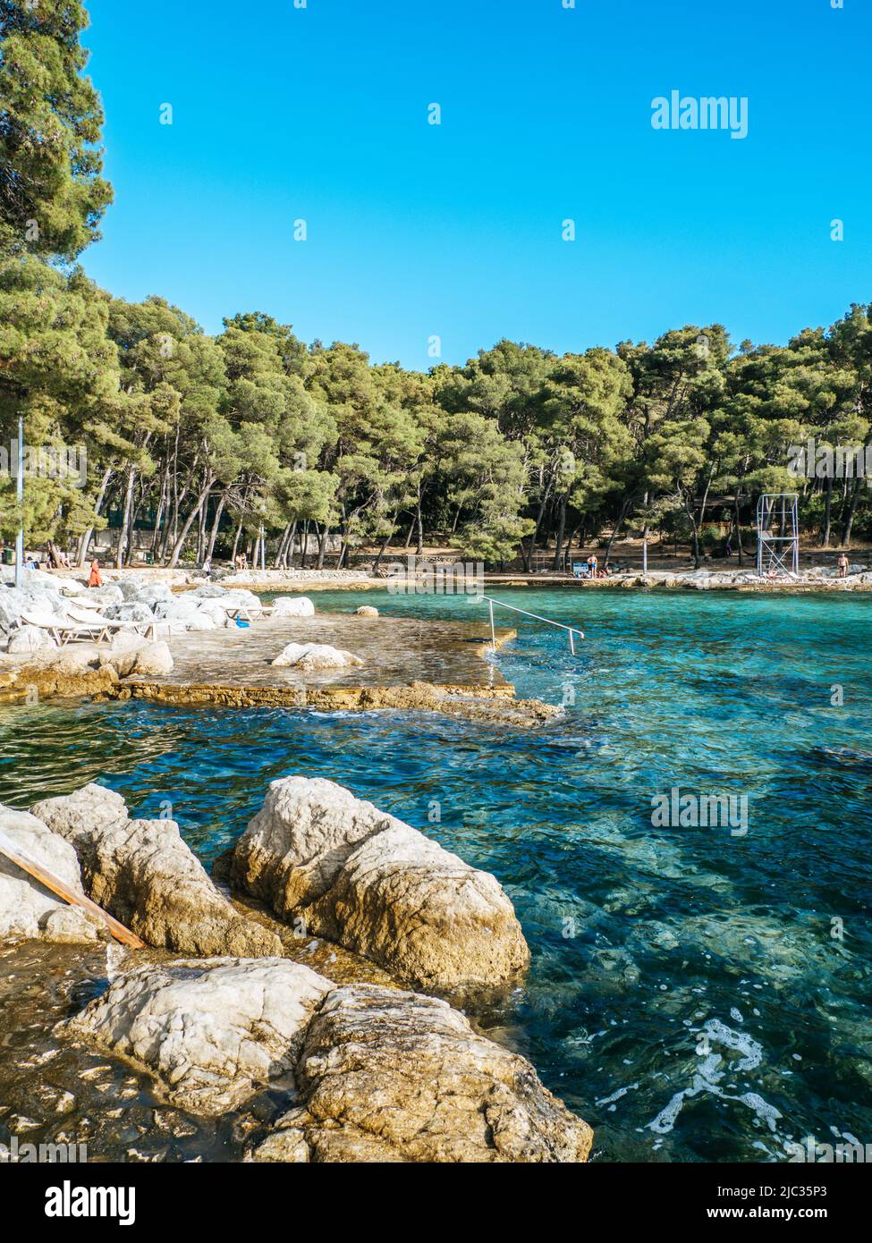 Kupalište Bene beach with sun chairs at the rocky shore Marjan Forest ...