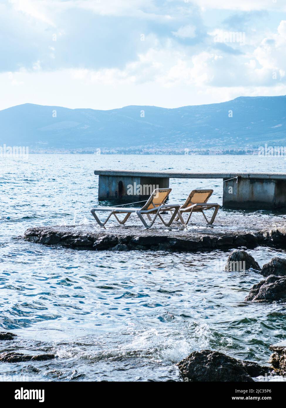 Kupalište Bene beach with sun chairs at the rocky shore Marjan Forest ...