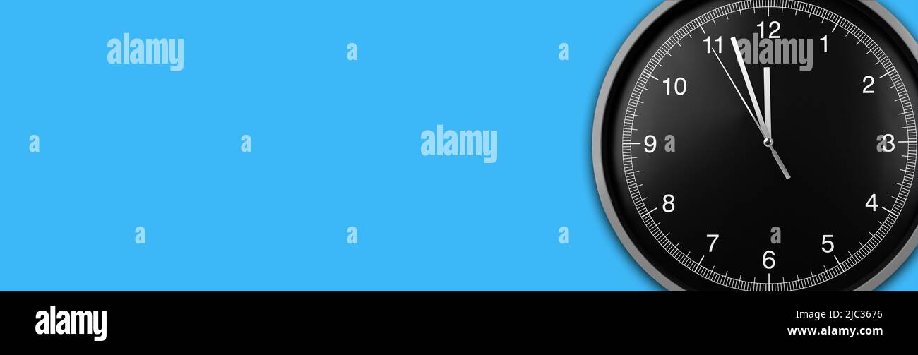 Wall clock showing twelve o'clock on blue background. Copy space Stock ...