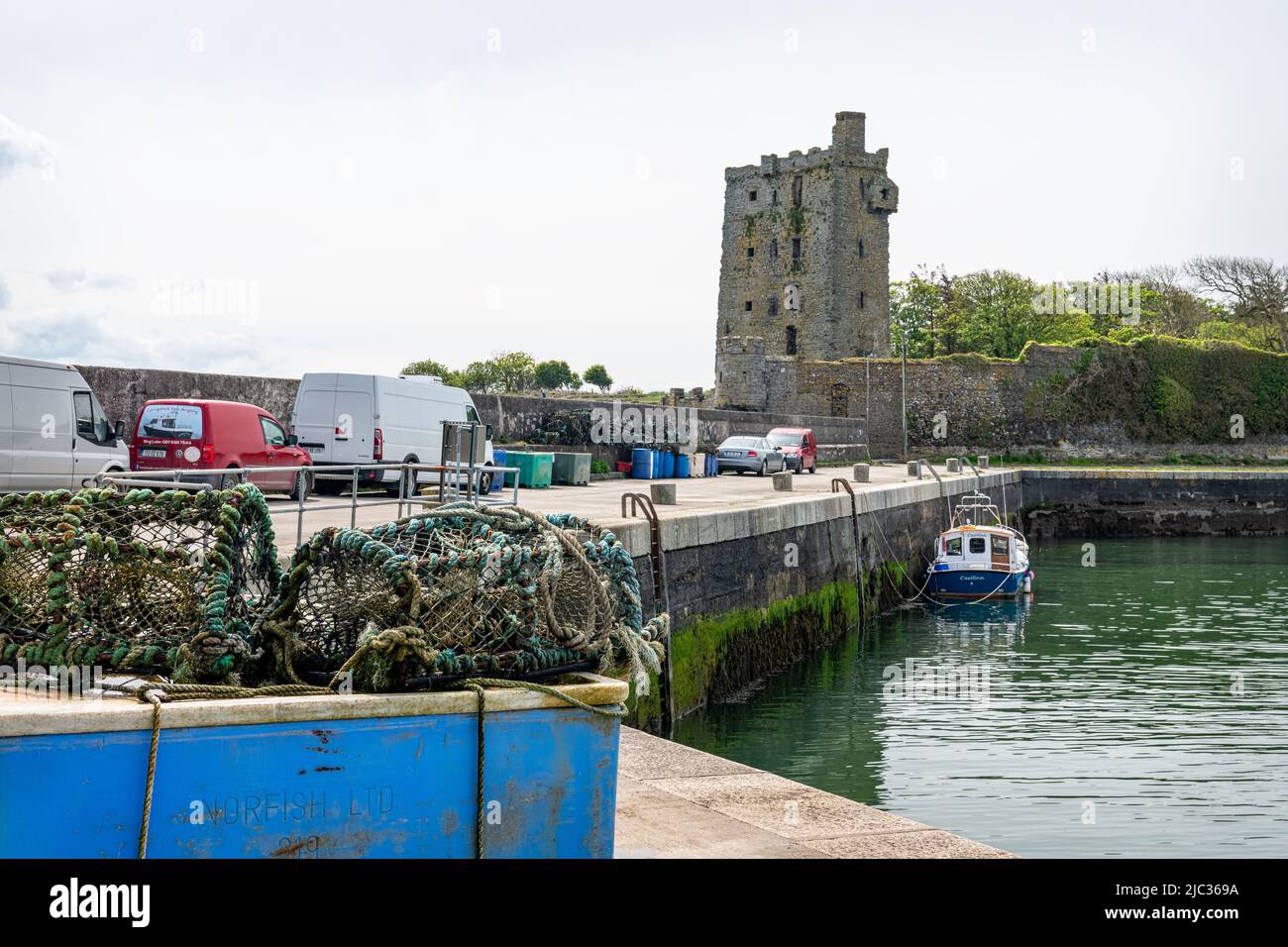 Carrigaholt Castle with the fishing pier in the foreground, County ...