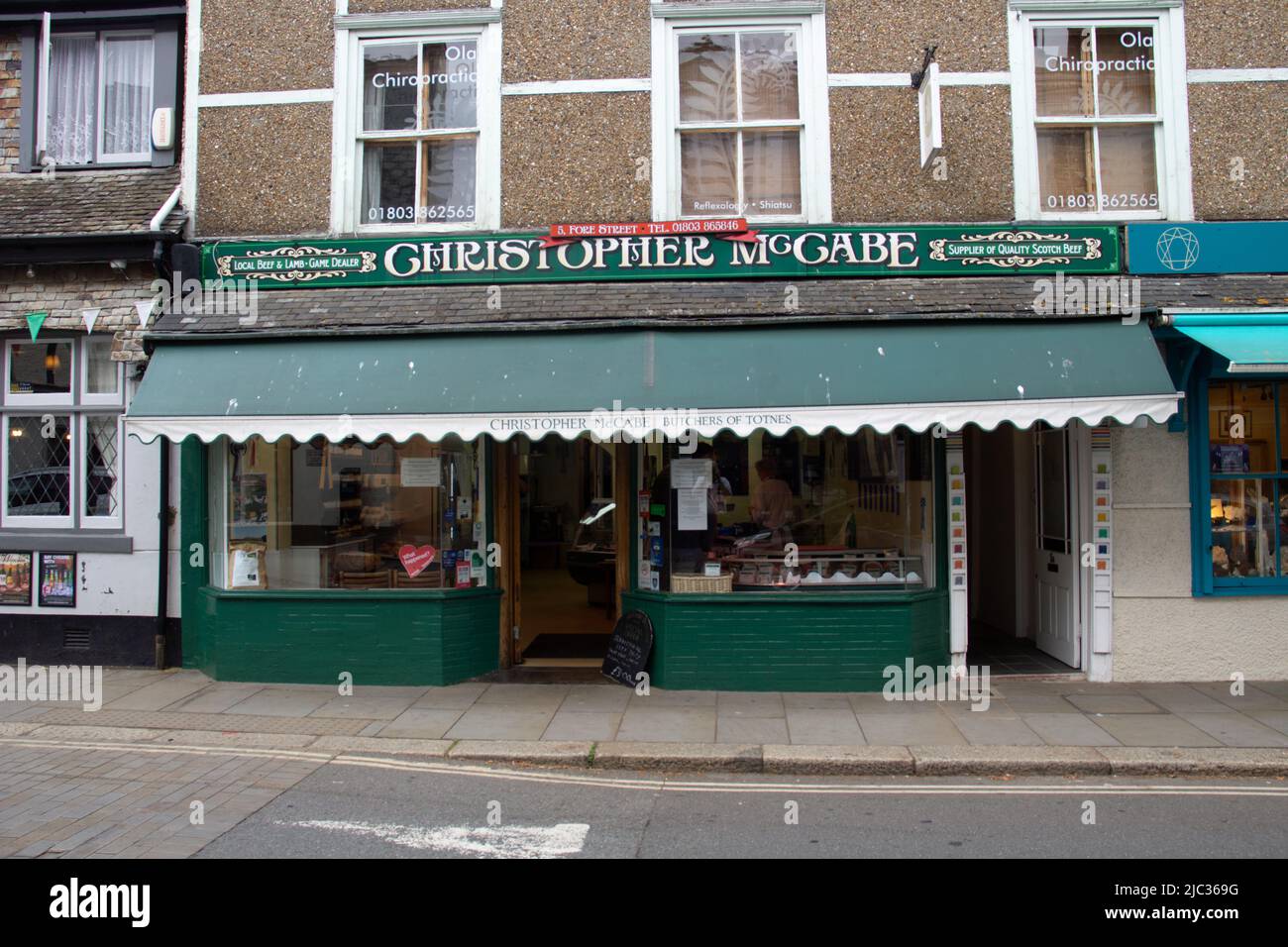 TOTNES, UK - JUNE 26, 2021 Christopher McCabe butchers shop on Fore ...