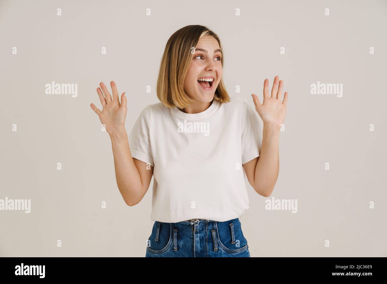 Young blonde woman screaming while gesturing on camera isolated over ...