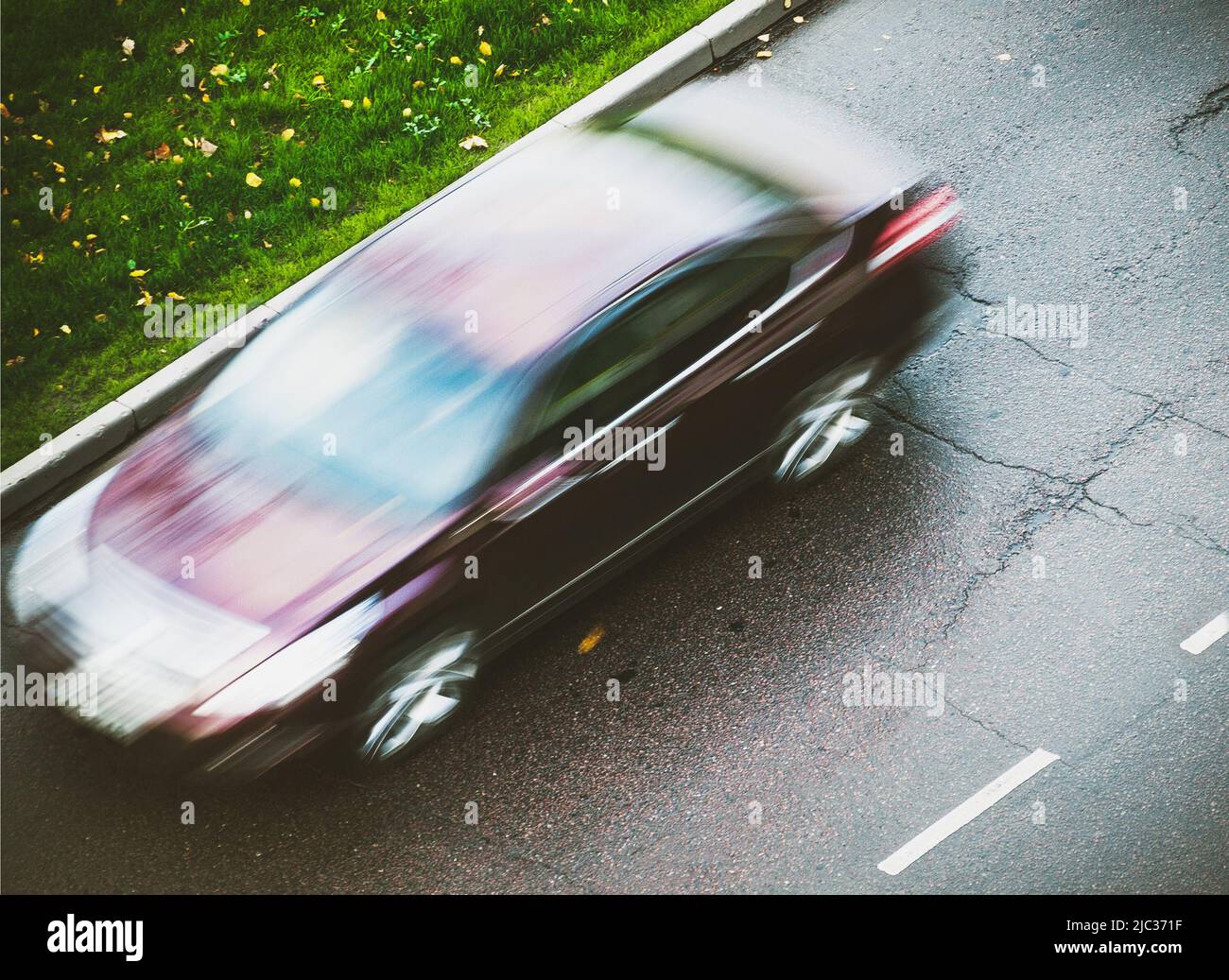 sedan car blurry moving on wet autumnal street Stock Photo - Alamy