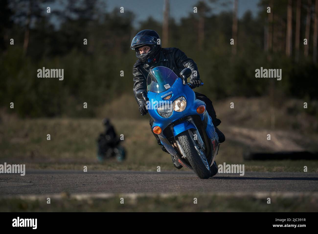12-09-2022 Riga, Latvia man riding motorcycle in asphalt road ...