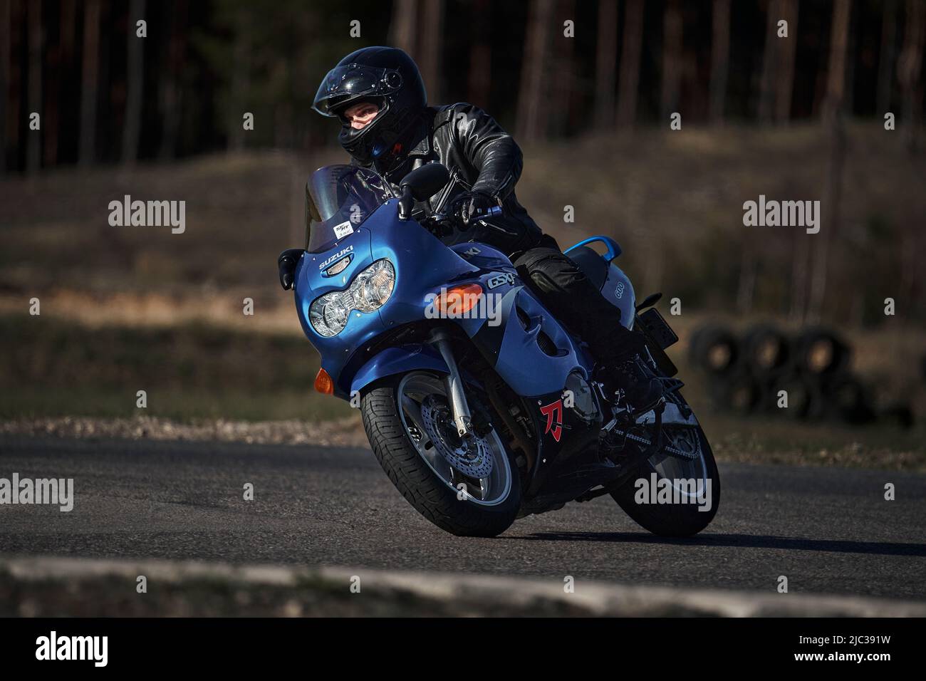 12-09-2022 Riga, Latvia man riding motorcycle in asphalt road ...