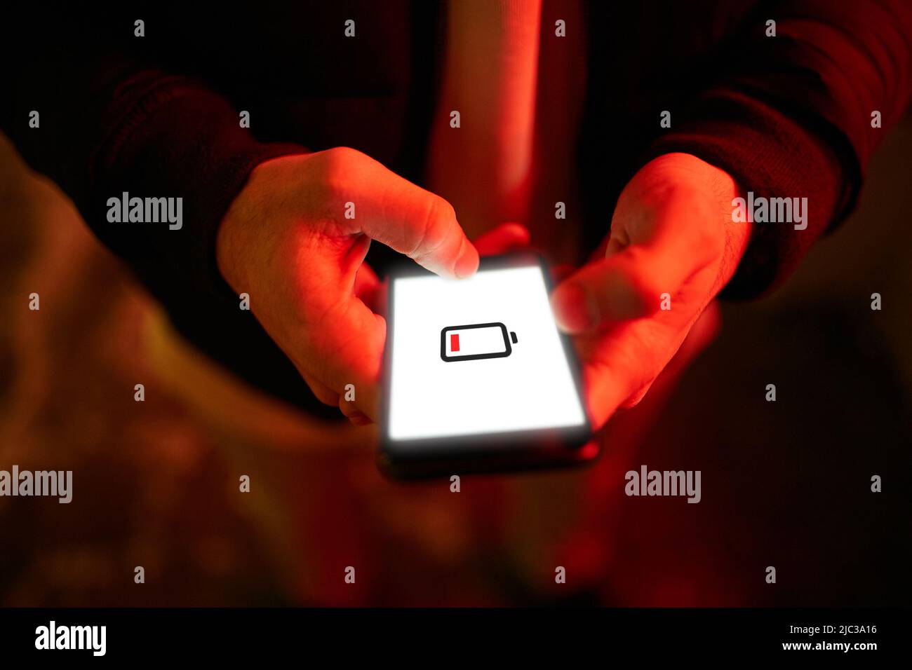 Man hands using smartphone battery low charged battery screen. Close-up ...