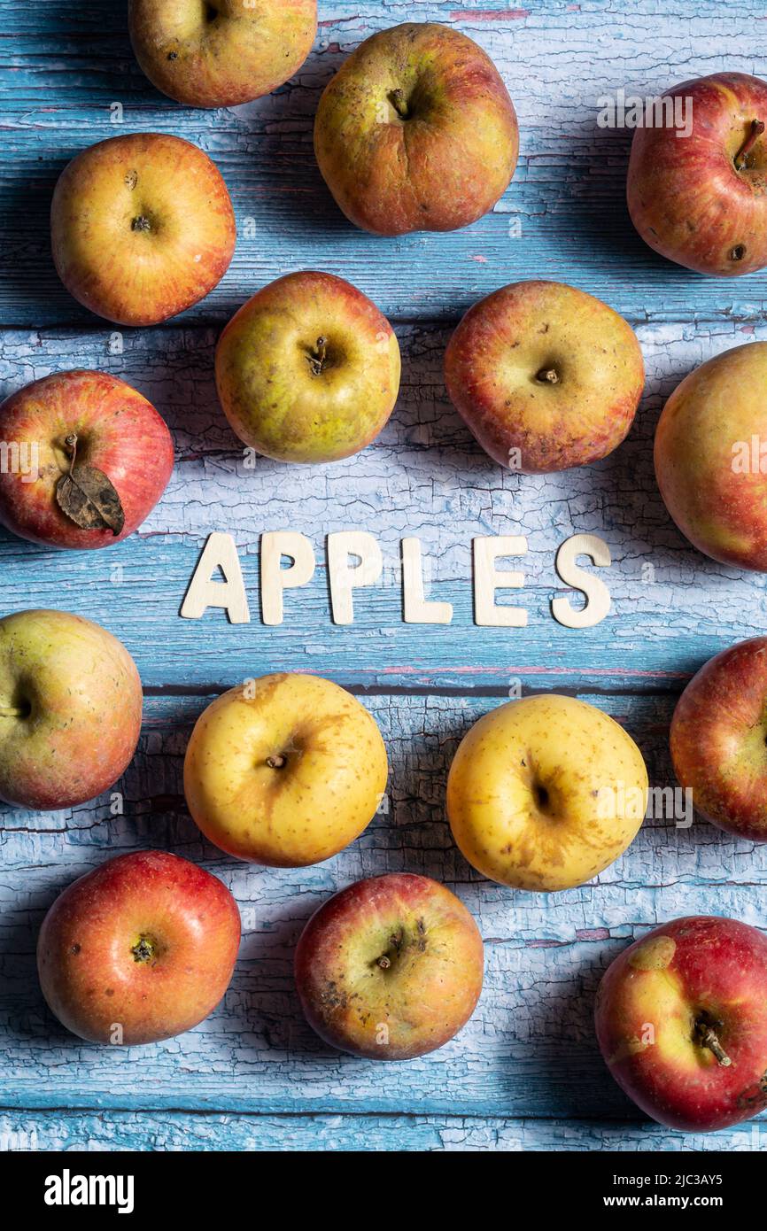 Yellow apples fruits background with apples word in wooden letters on a ...
