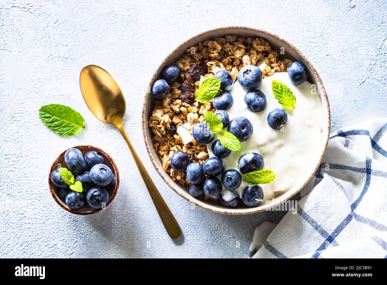 Greek Yogurt, granola and blueberry at light stone table Stock Photo ...