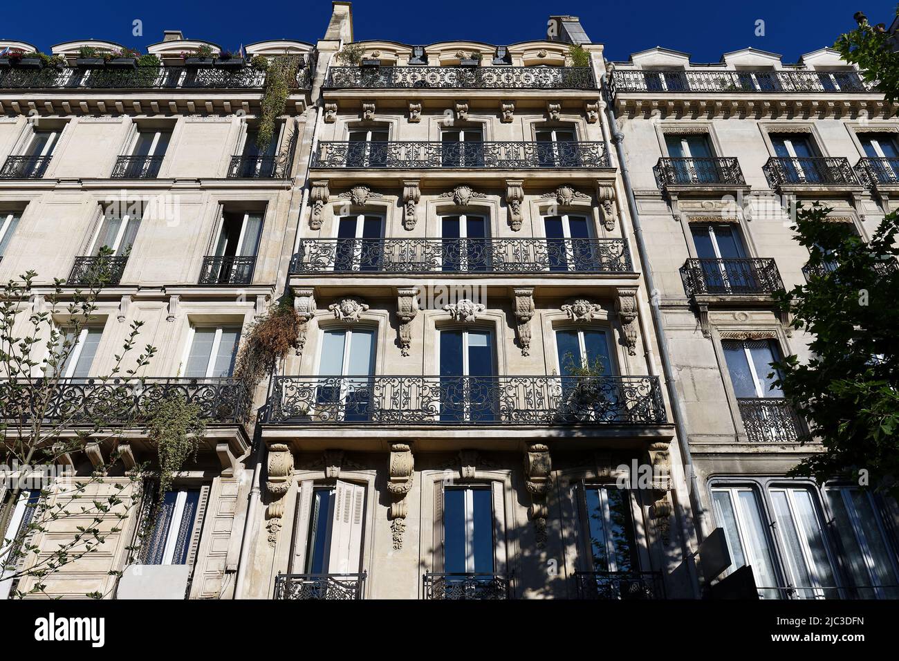 The facade of traditional French house with typical balconies and ...