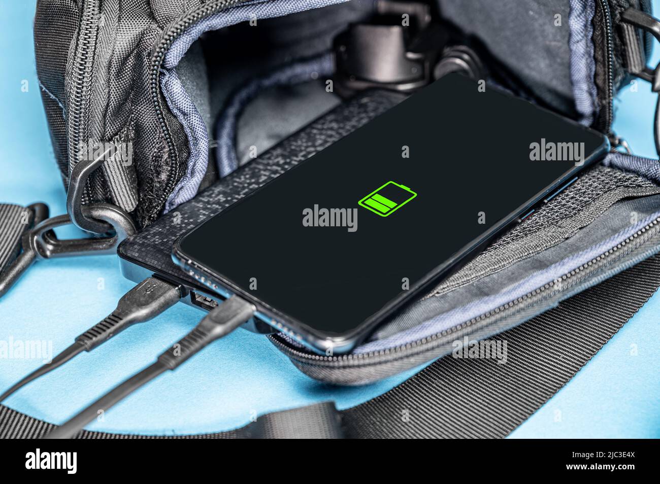 Smartphone charging. The mobile phone is charged from the power bank ...